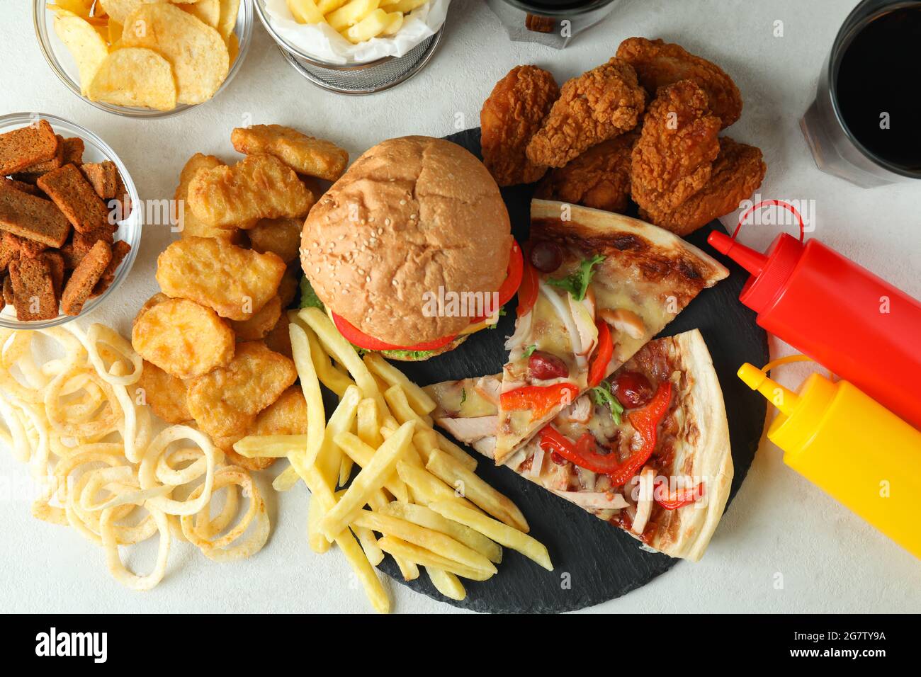 Concept of fast food on white textured table Stock Photo - Alamy