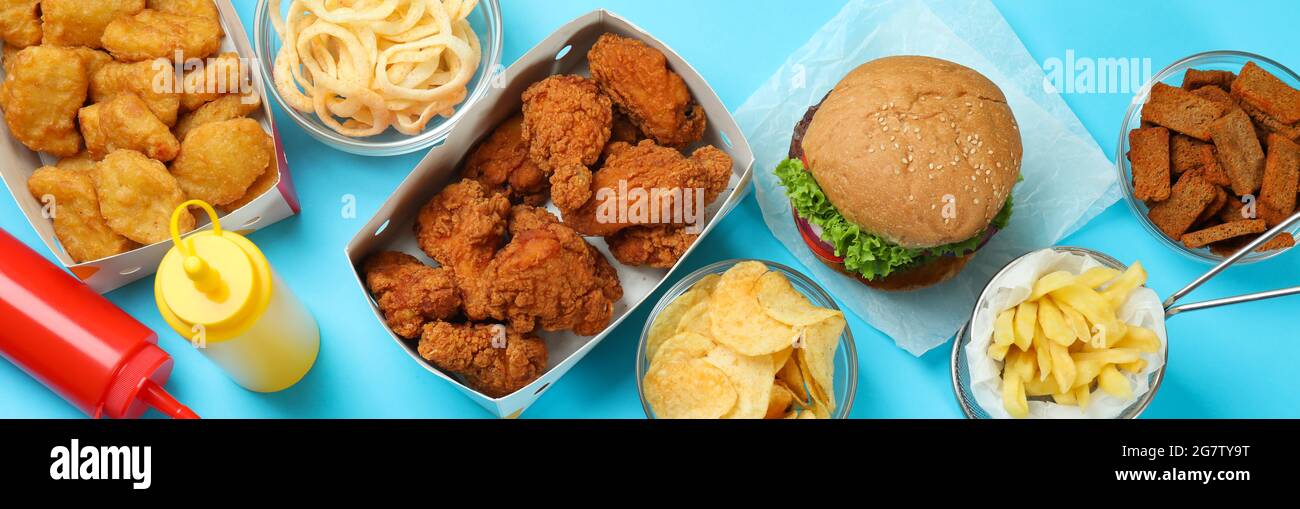Concept of fast food on blue background Stock Photo - Alamy