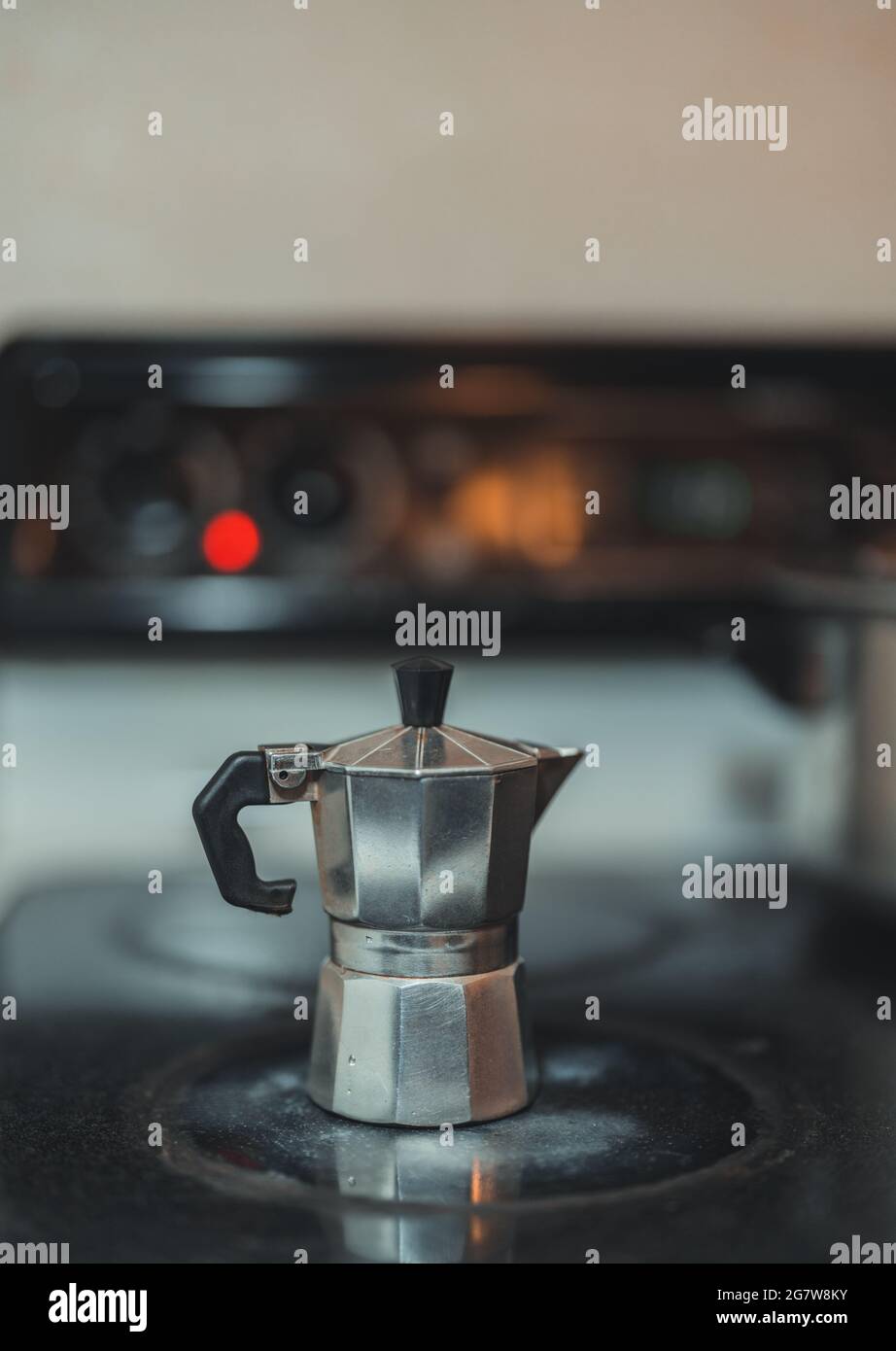 Vertical shot of a small tea kettle on a blurred background Stock Photo ...