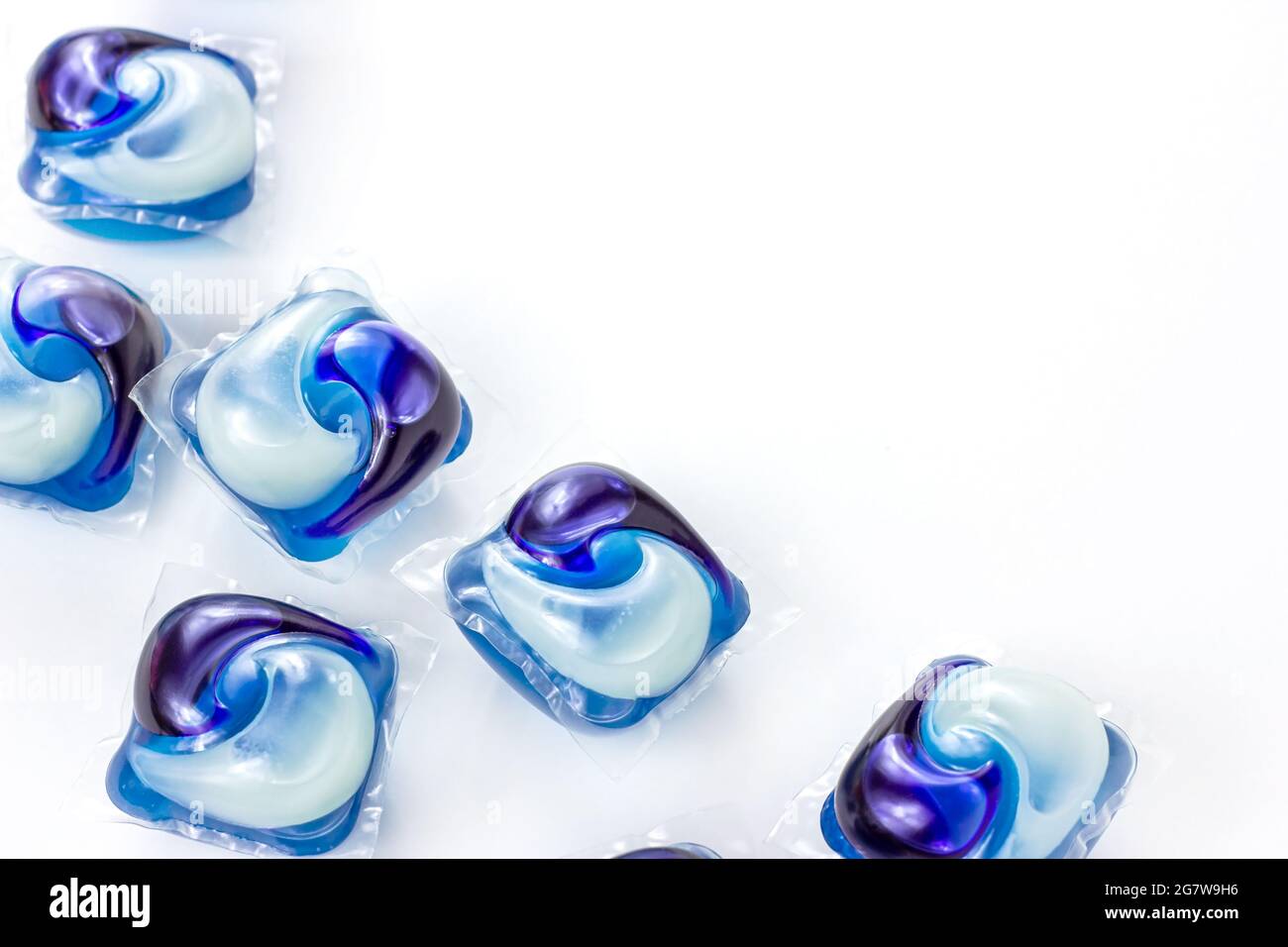 Bright blue washing pods and capsules with liquid detergent for machine ...