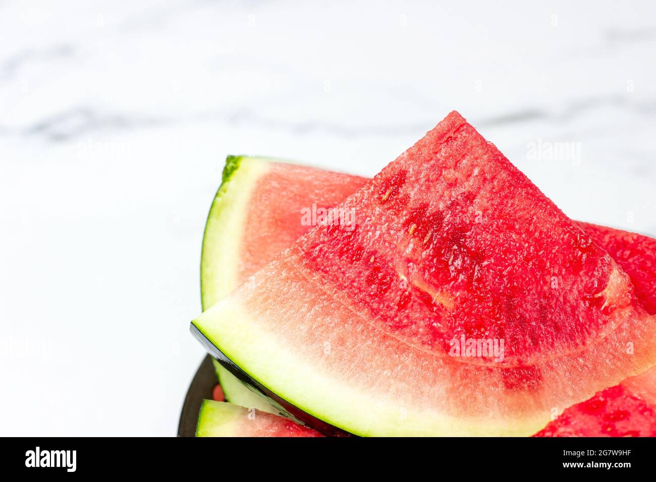 Bright sweet red and green watermelon slices in summer on light ...