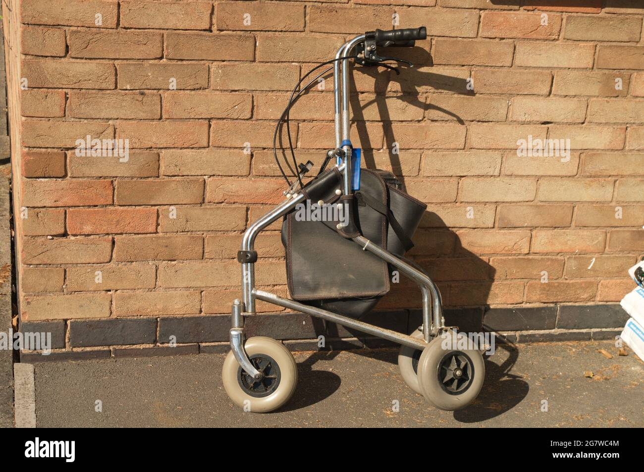 Folding, wheeled Zimmer frame leaning against a wall Stock Photo - Alamy
