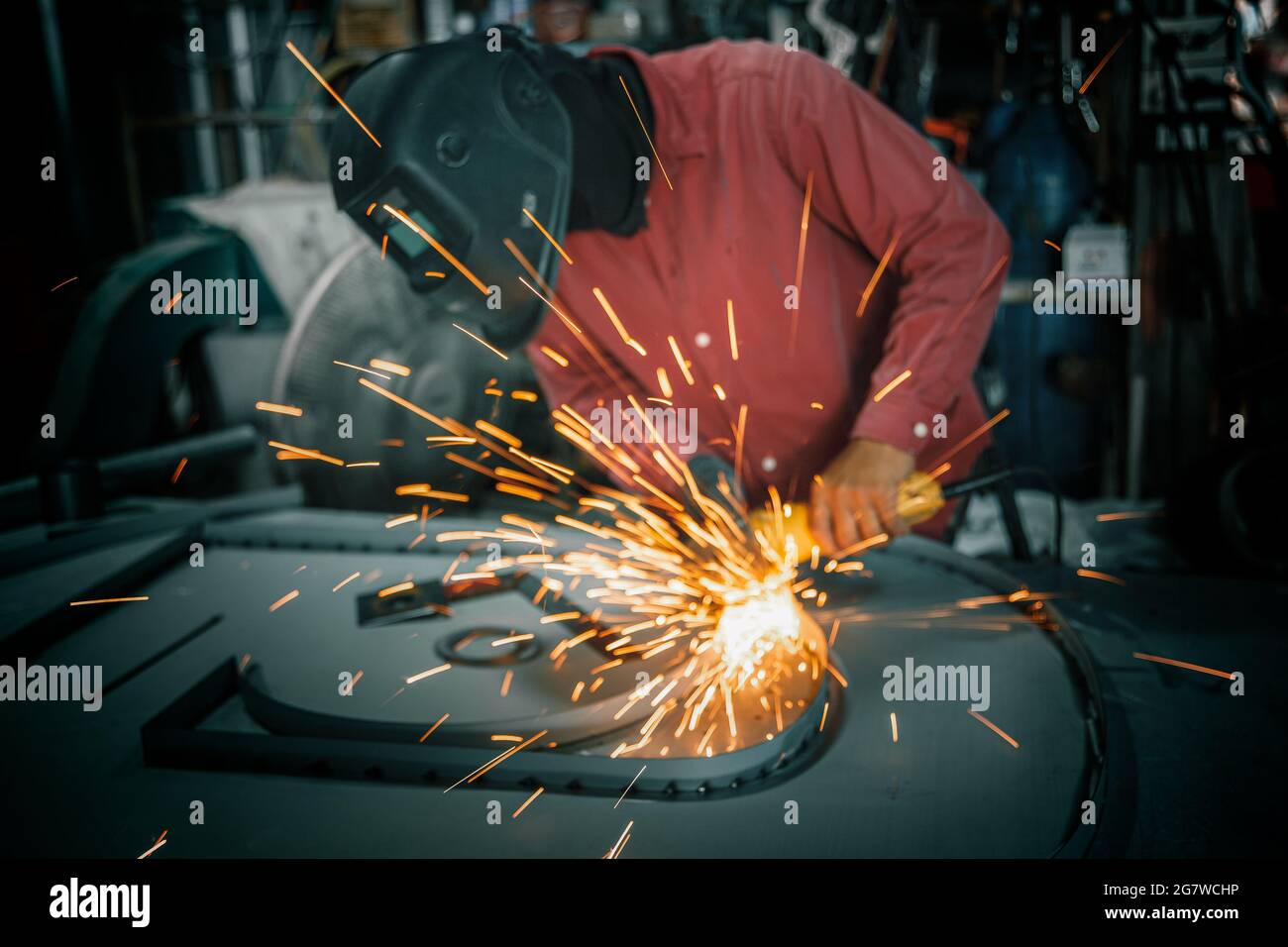 Welder used grinding stone on steel in factory with sparks, Welding ...
