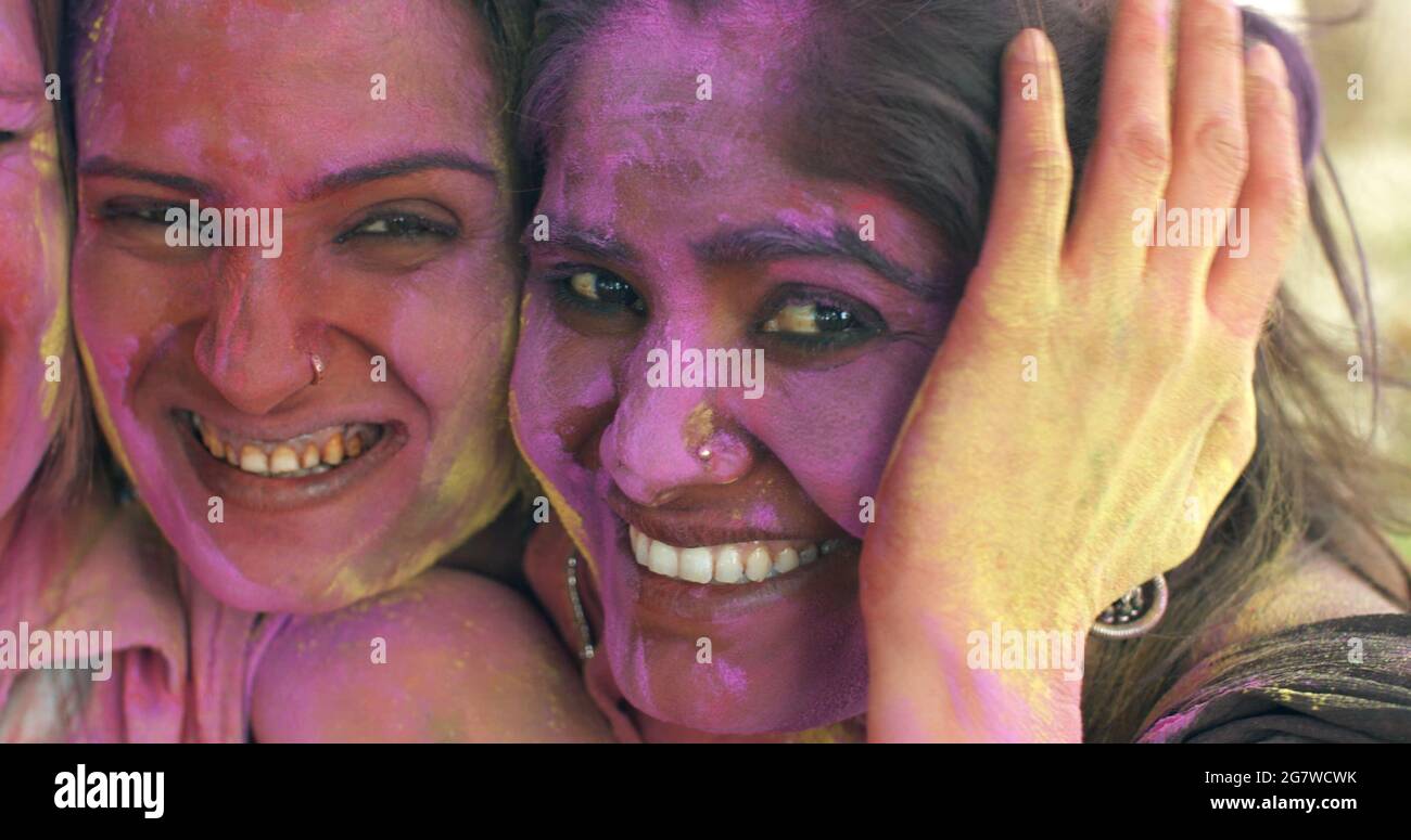 Portrait of two female with painted faces at the Holi Hindu festival of ...