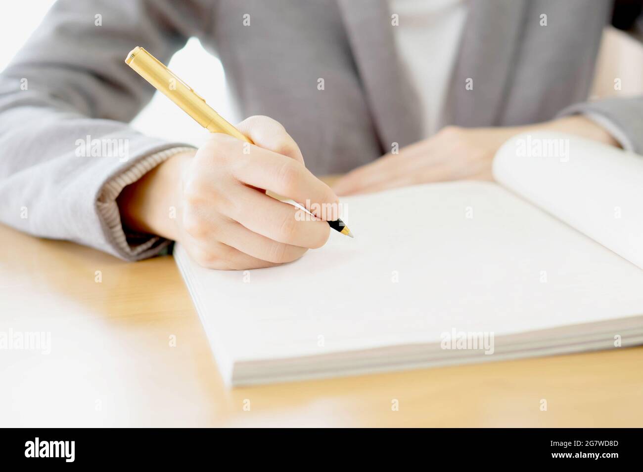 Woman writing on paper Stock Photo - Alamy