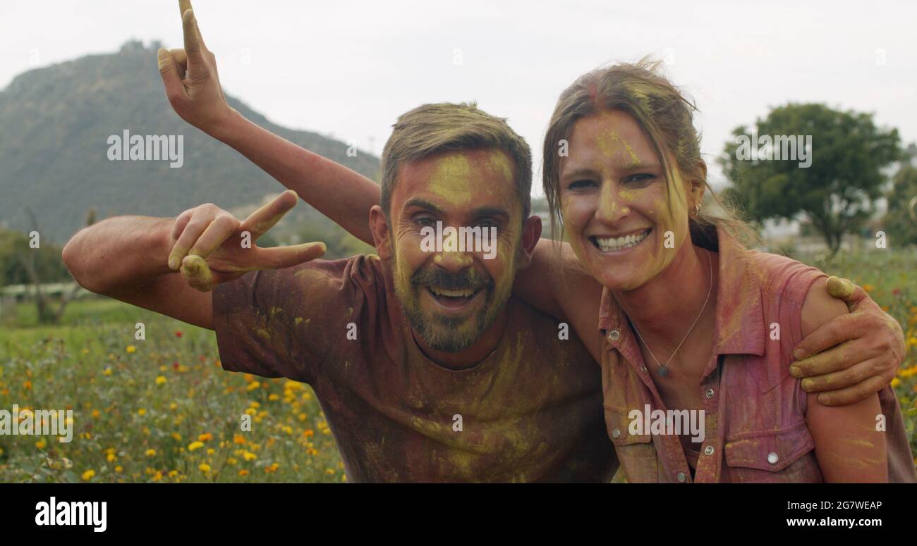 Happy couple with painted faces at the Holi Hindu festival of Color in ...