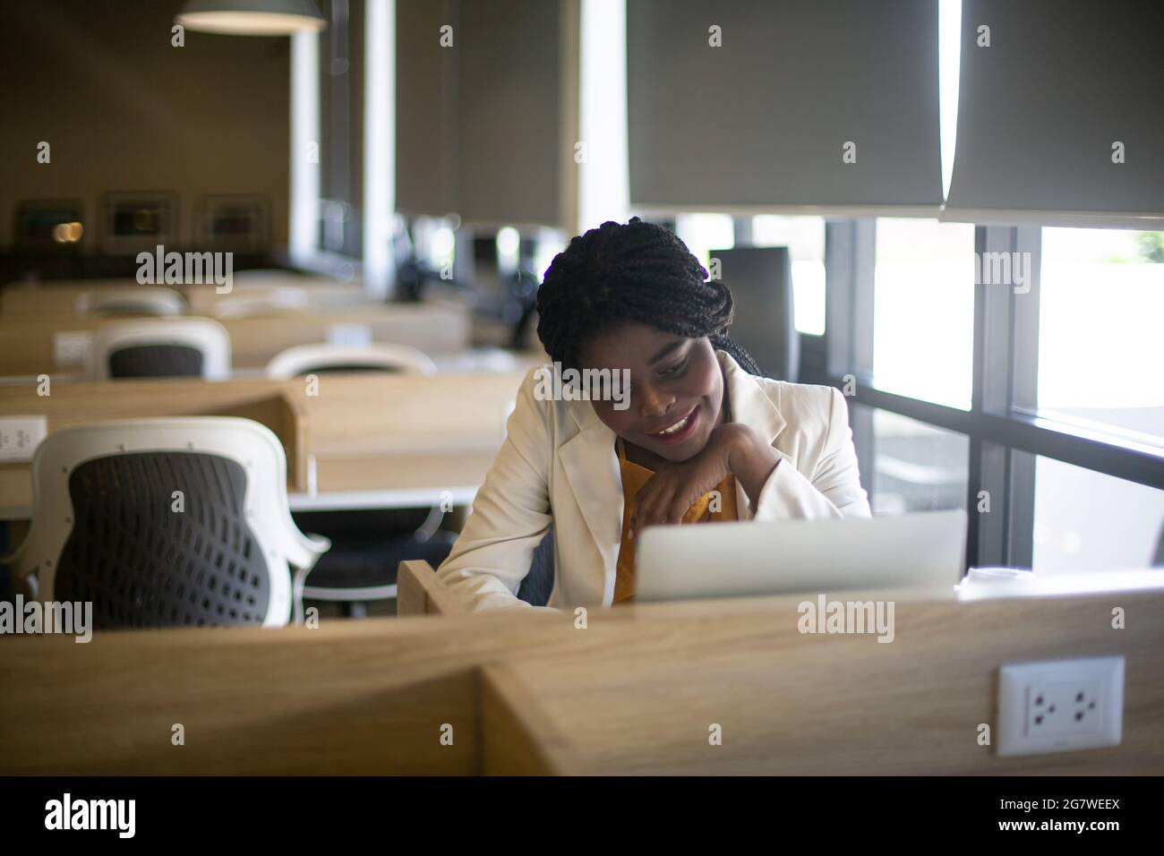 Young African American woman working using computer laptop concentrated ...