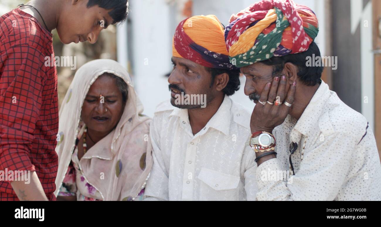 Group of South Asian people in traditional Indian clothing having a ...