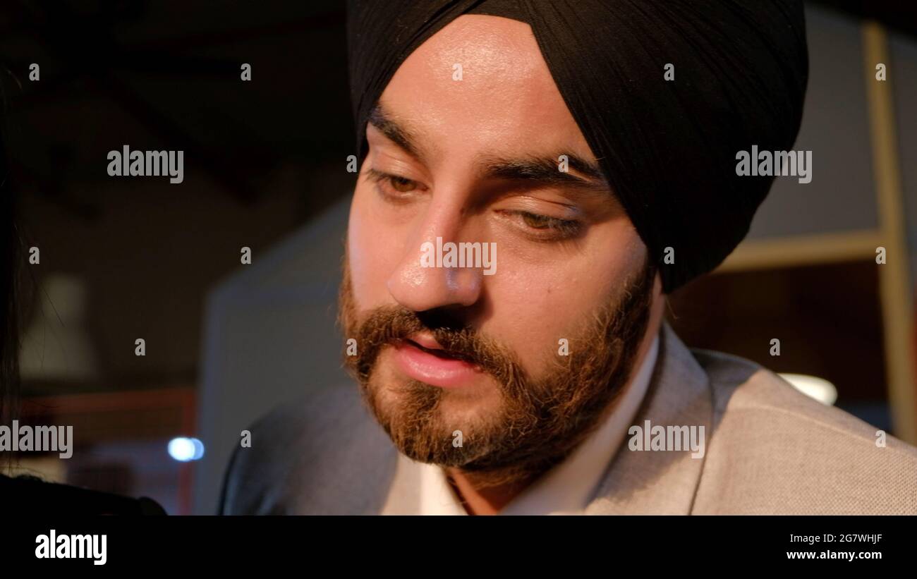 Sikh businessman from India wearing the black turban in a gray suit in ...