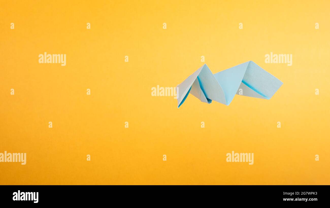 paper blue airplane on yellow background travelling concept, Ukrainian ...