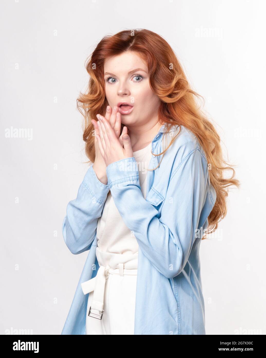 Shocked ginger woman posin like Model in studio Stock Photo - Alamy
