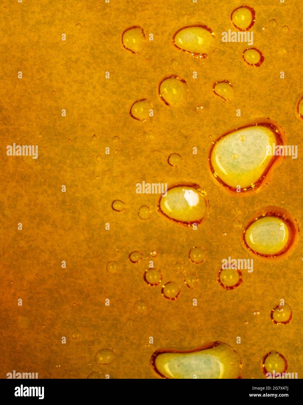 vertical texture golden cannabis wax, marijuana dab macro background ...