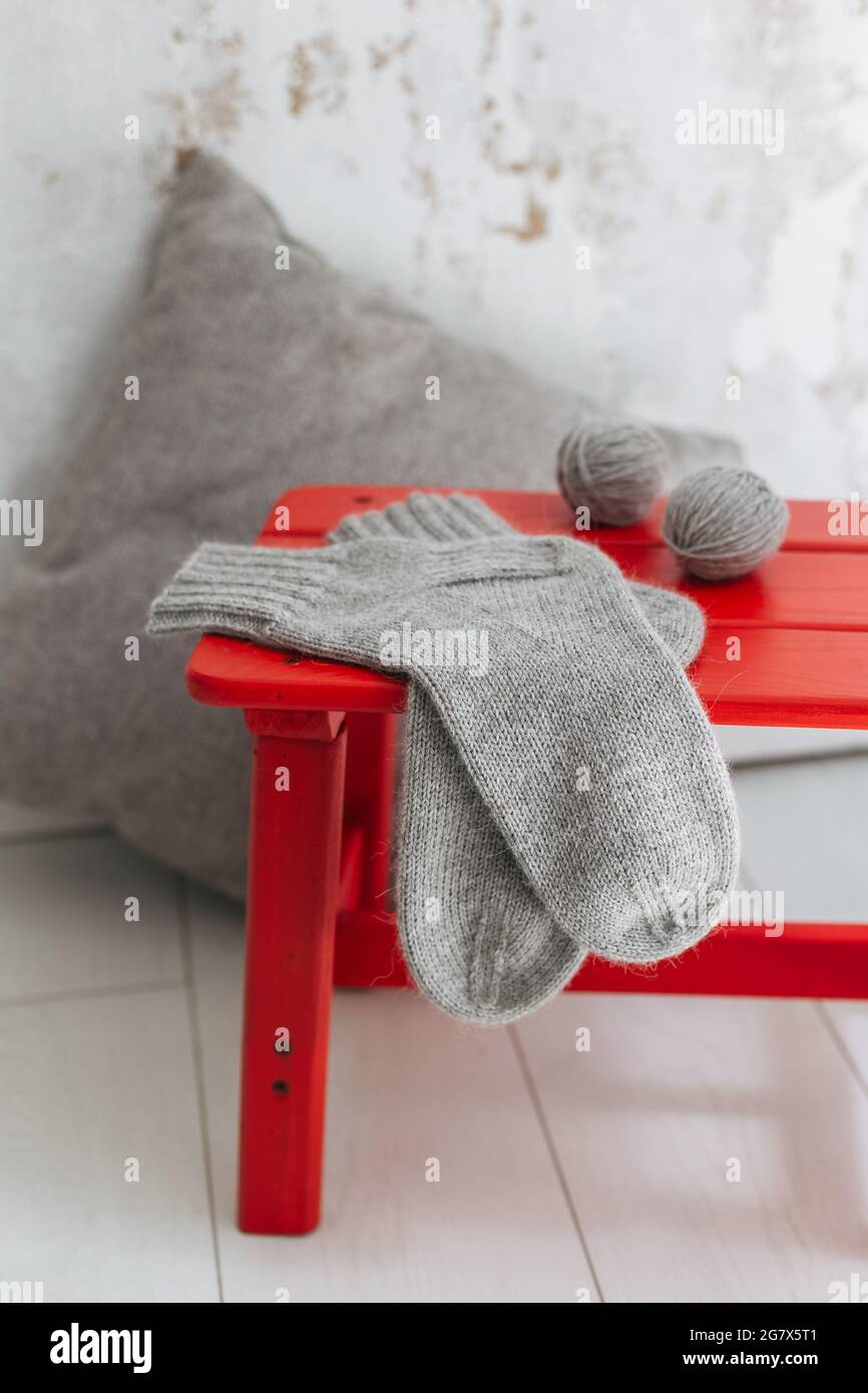 Hand knitted socks with yarn balls on a red stool. Concept for handmade ...