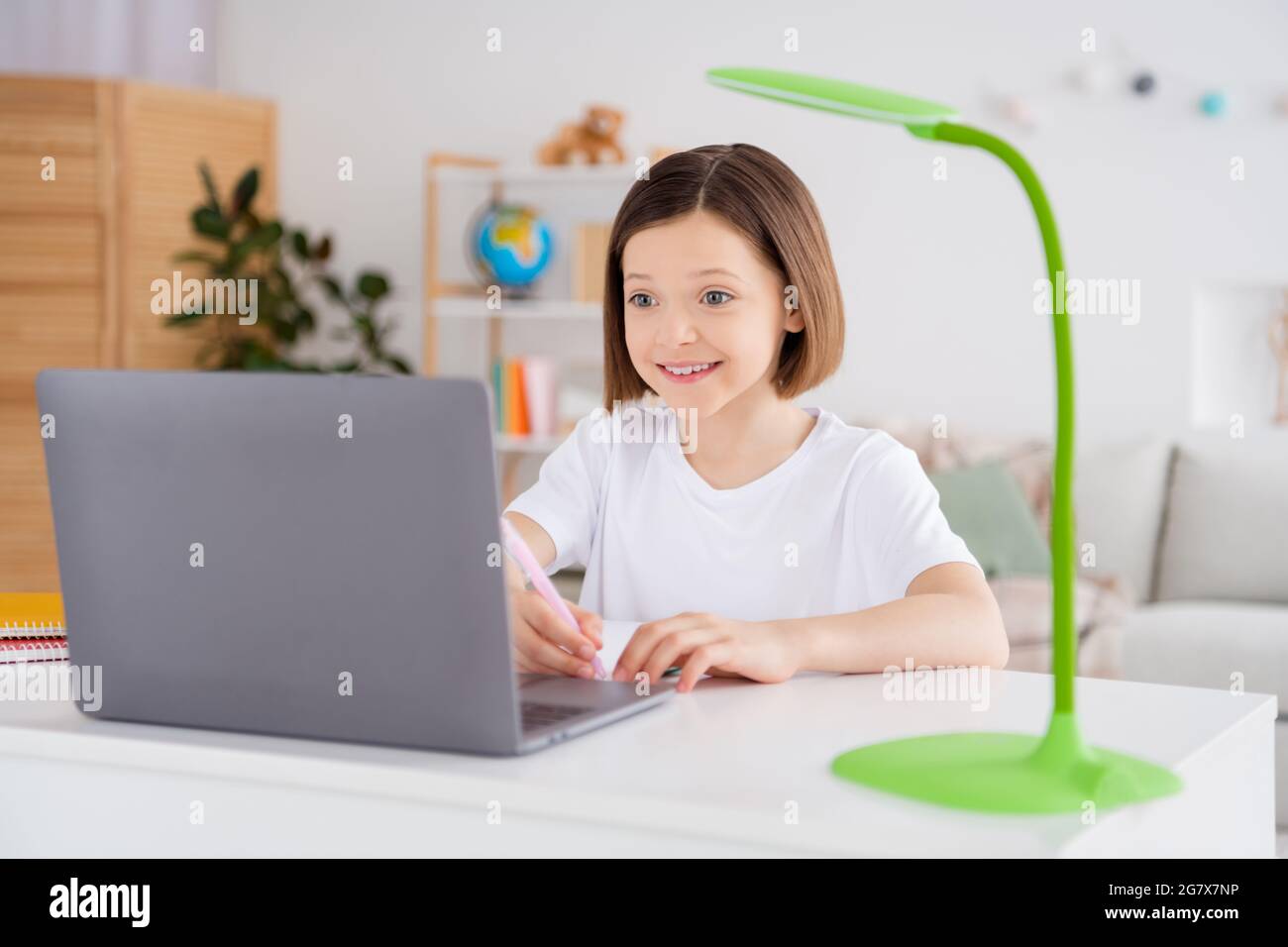 Photo portrait little girl writing learning with laptop online lesson ...