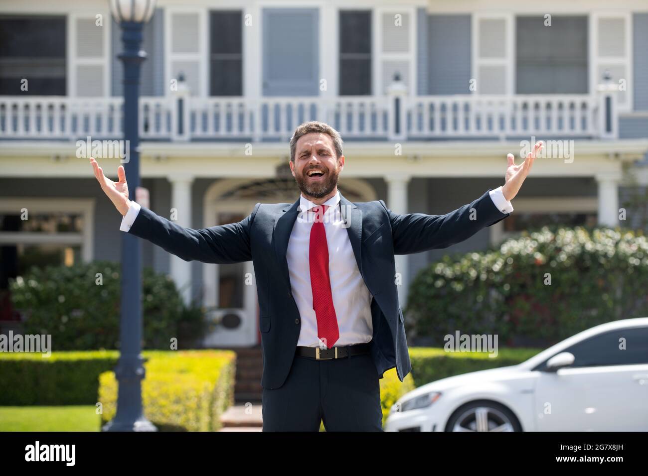 Excited real estate agent. Handsome amazinf businessman over new house ...