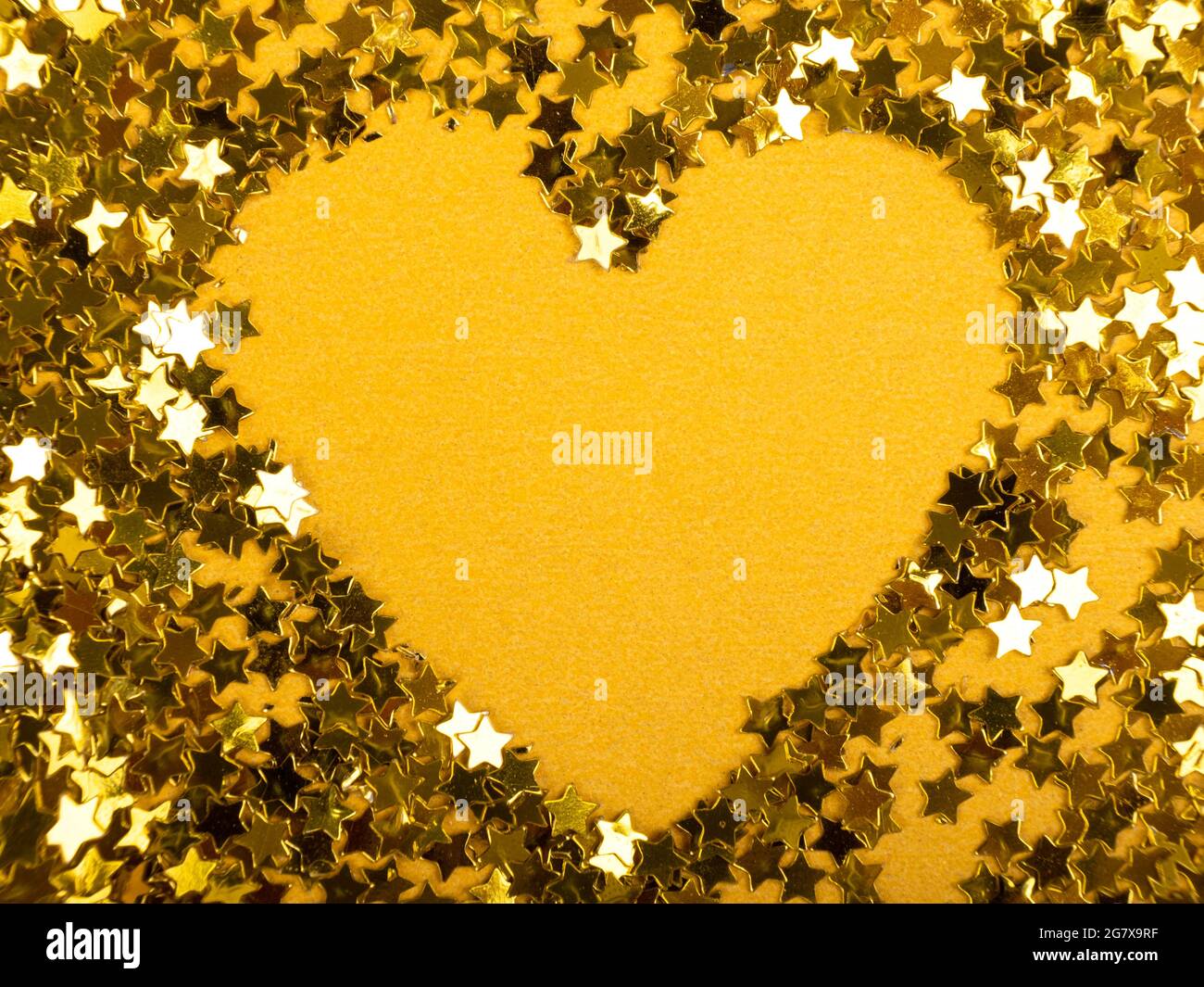 valentines day heart of gold stars on a yellow background Stock Photo ...