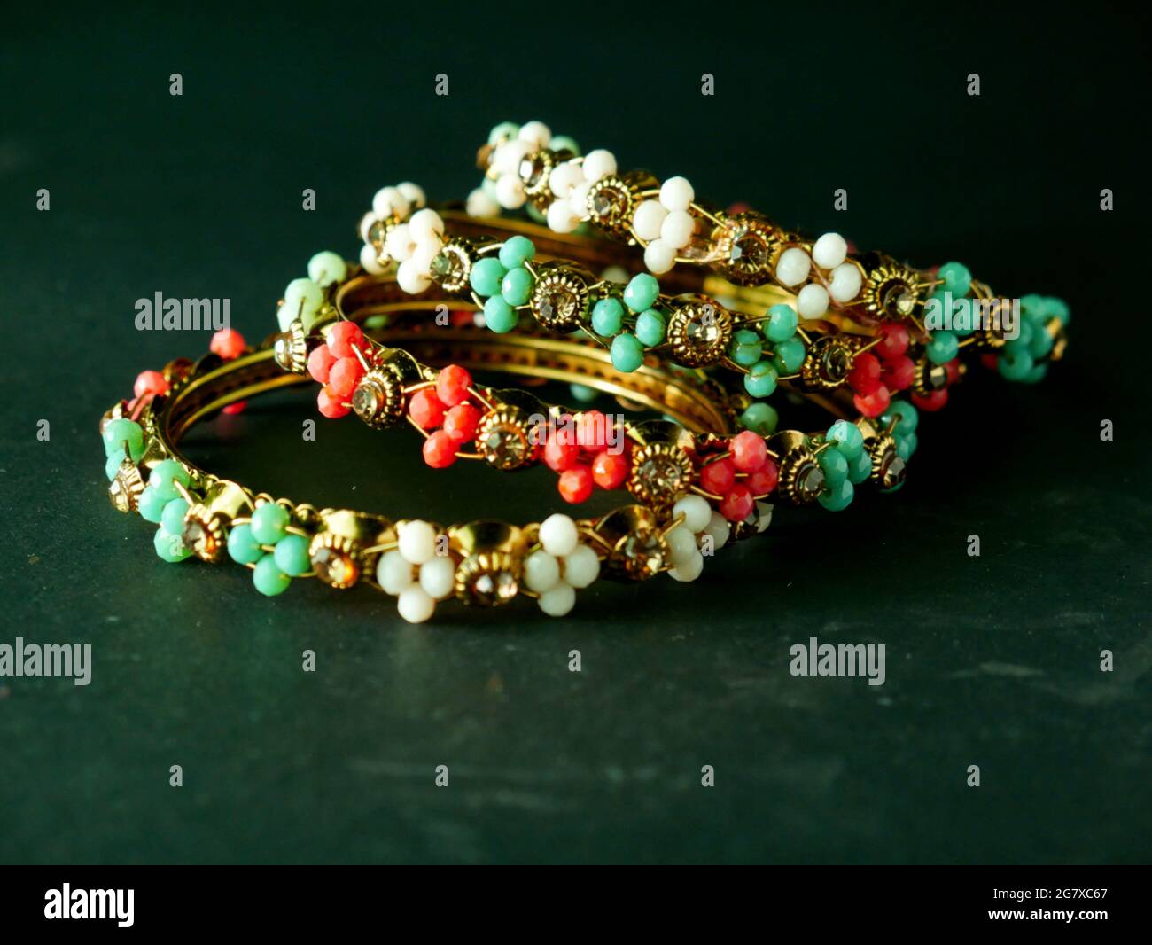 attractive bangle presenting isolated at black background, female ...