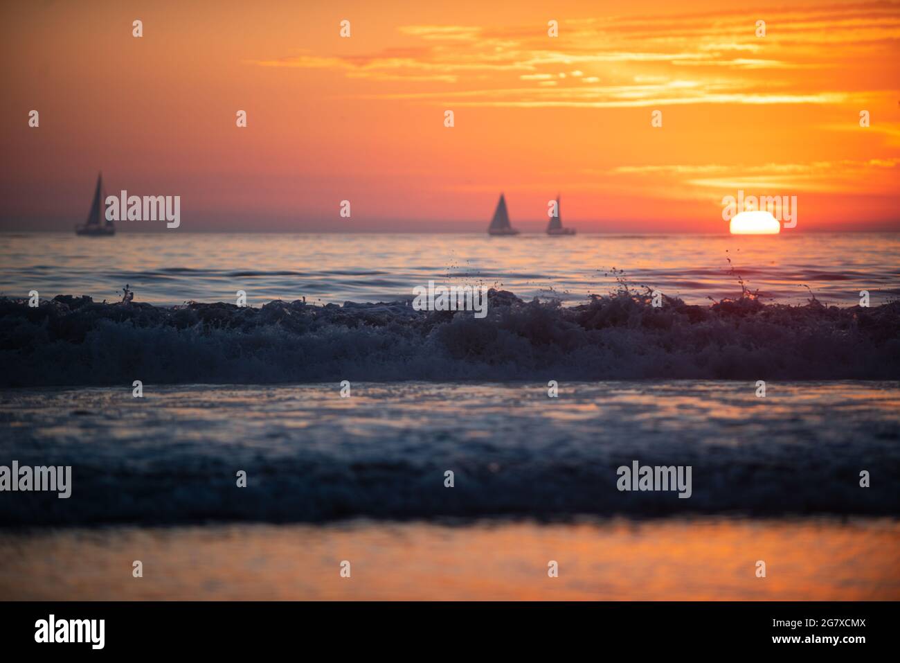 Calm sea with sunset sky and sun through the clouds over. Ocean and sky ...