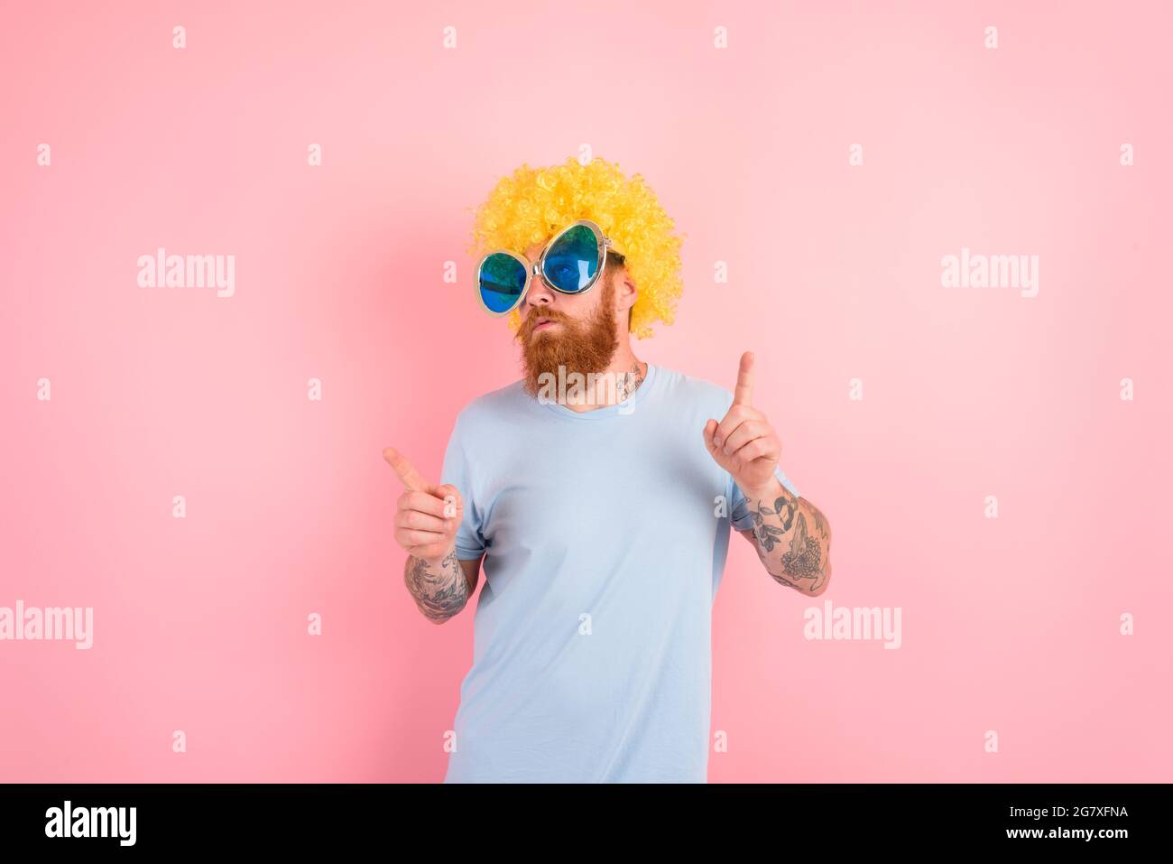 Funny serious man with peruke and sunglasses dances Stock Photo - Alamy