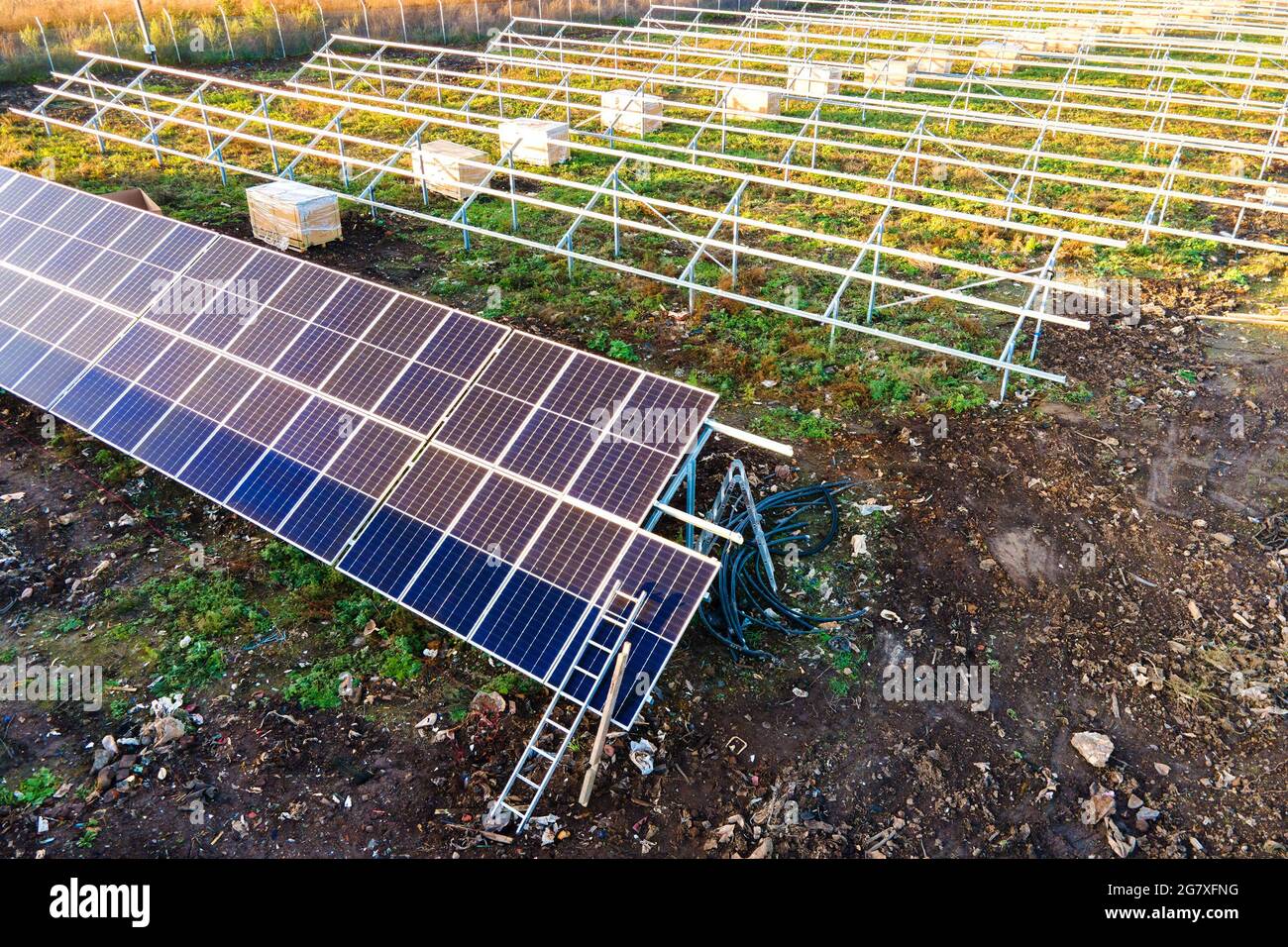 Aerial view of solar power plant under construction on green field ...