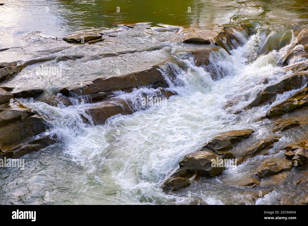 Mountain river with small waterfall with clear turquoise water falling ...
