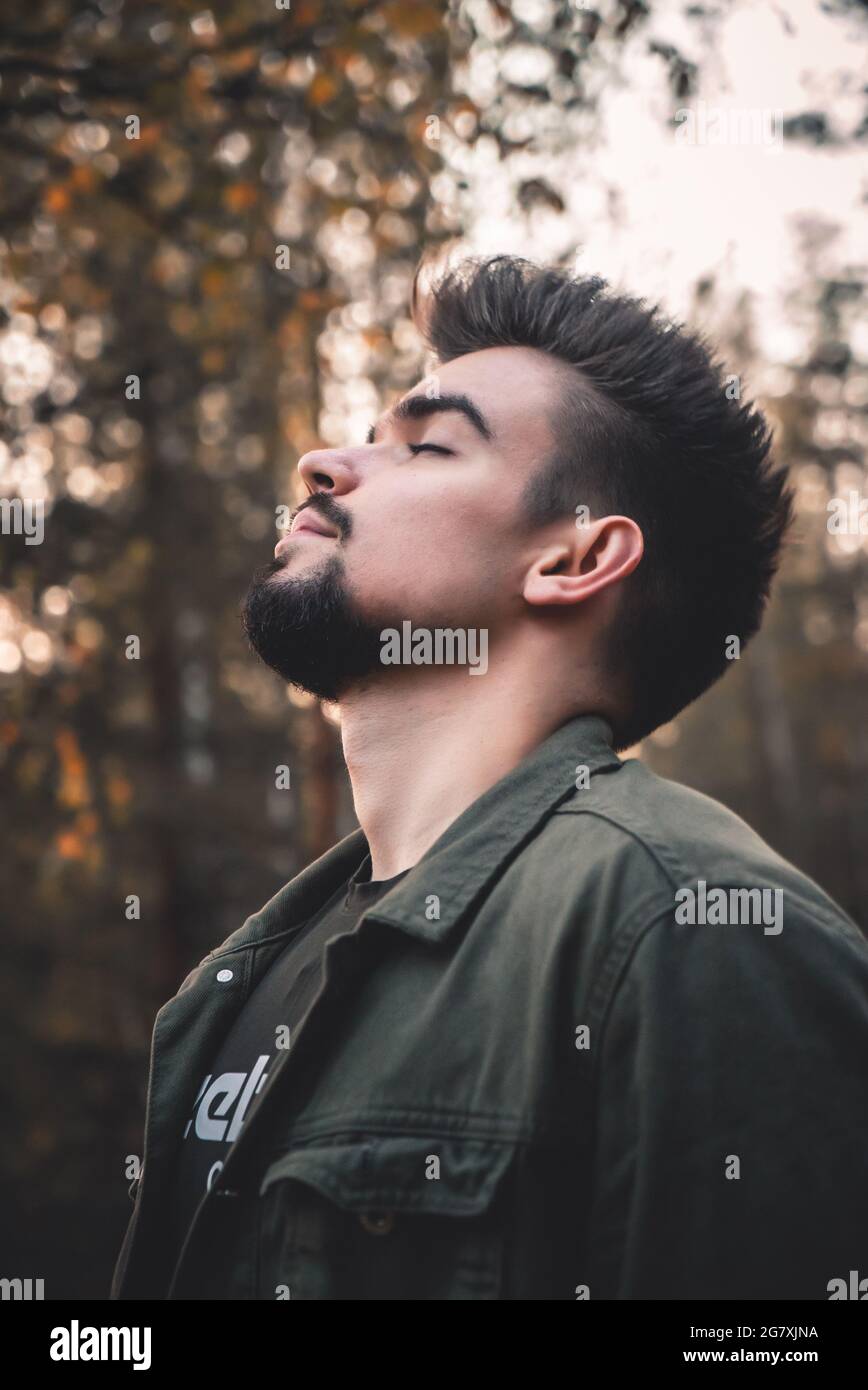 Portrait of a young Russian man with a beard and a stylish hairstyle in ...