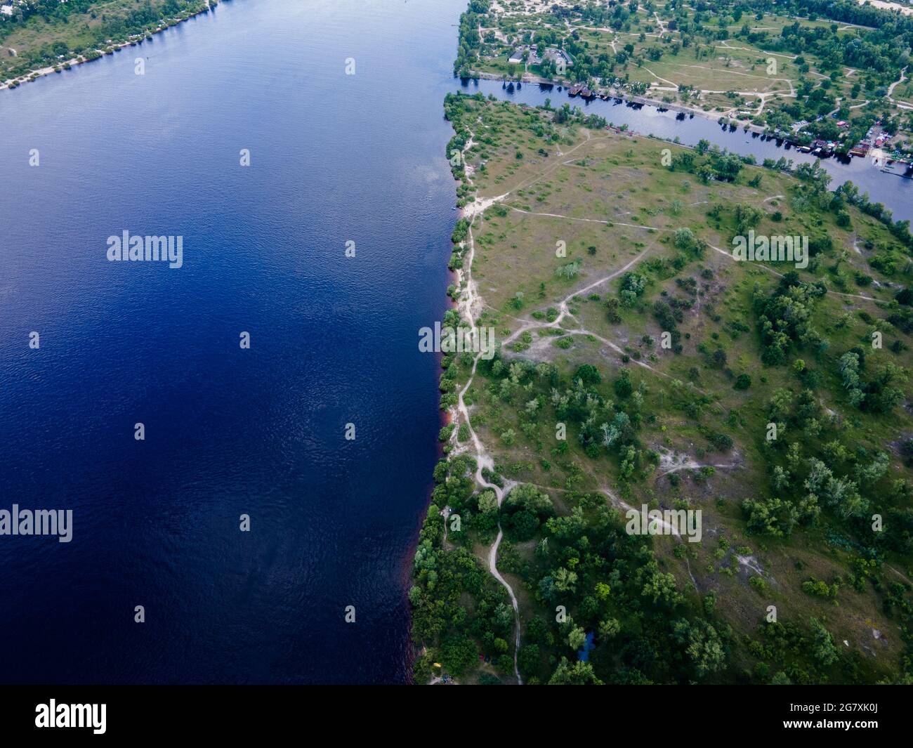Aerial view from a drone on a fresh river among a green meadow in ...