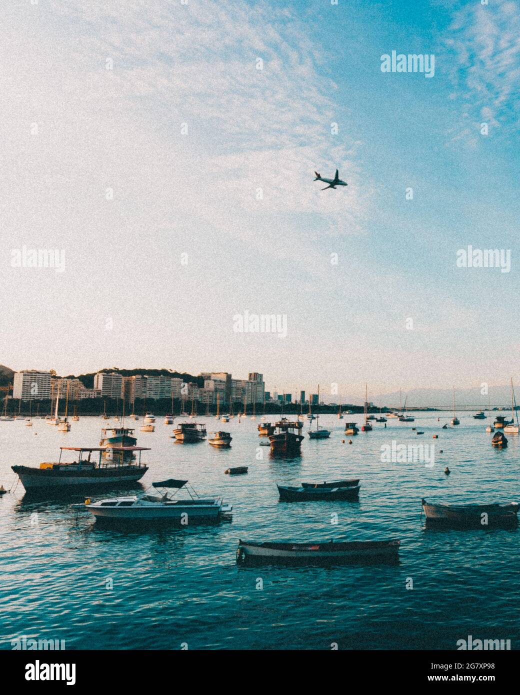 Airplane flying over boats floating in a sea in Rio de Janeiro Stock ...
