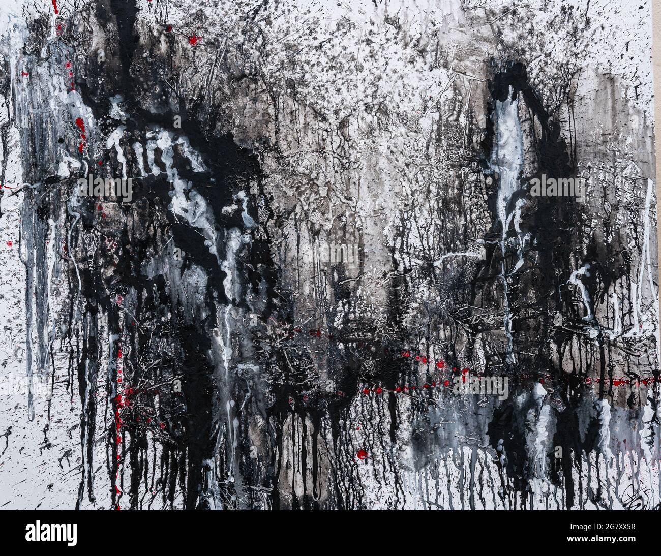 Closeup of black color paint splash with red dots on the white ...