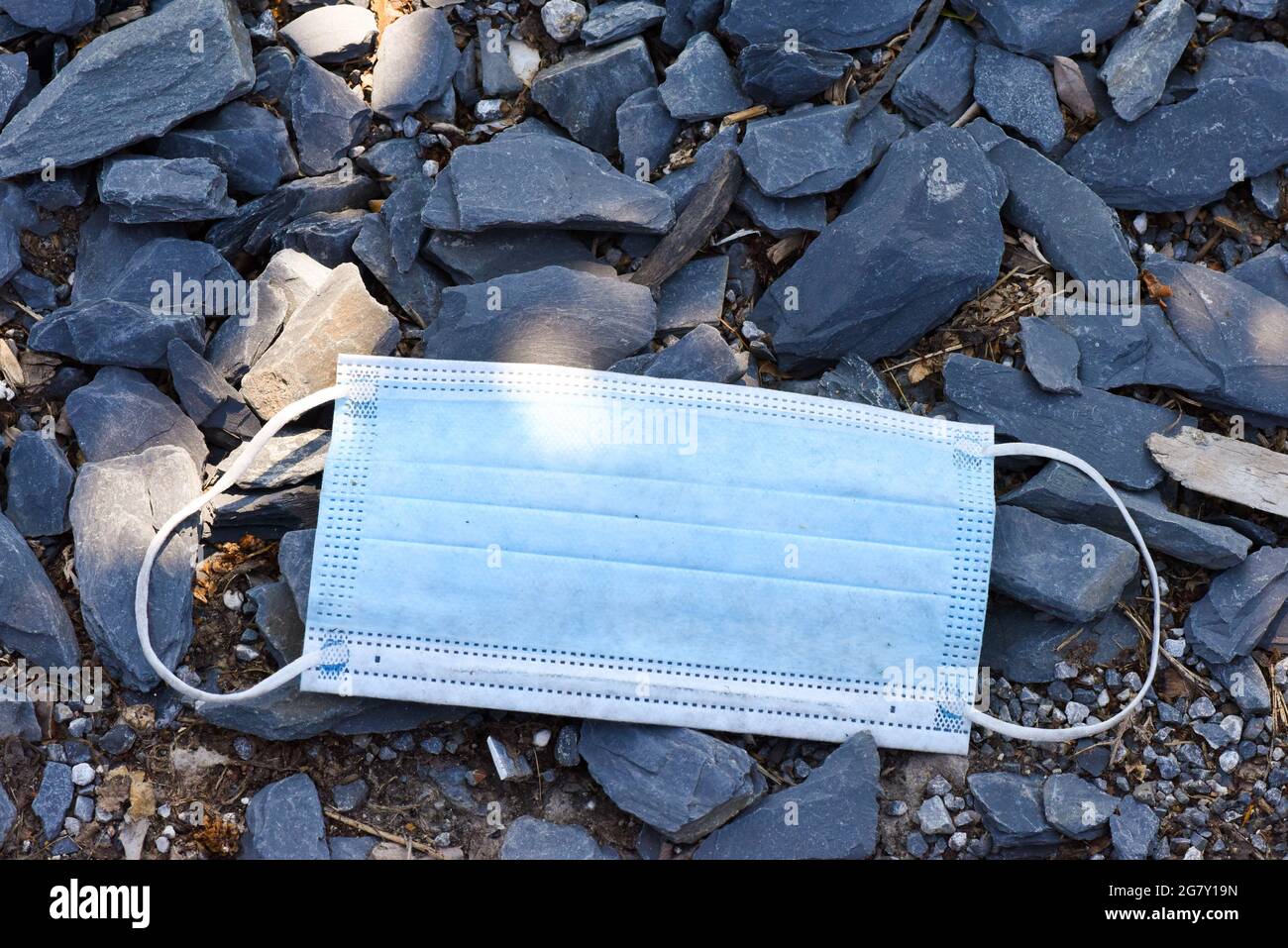 Face mask thrown on the ground Stock Photo - Alamy