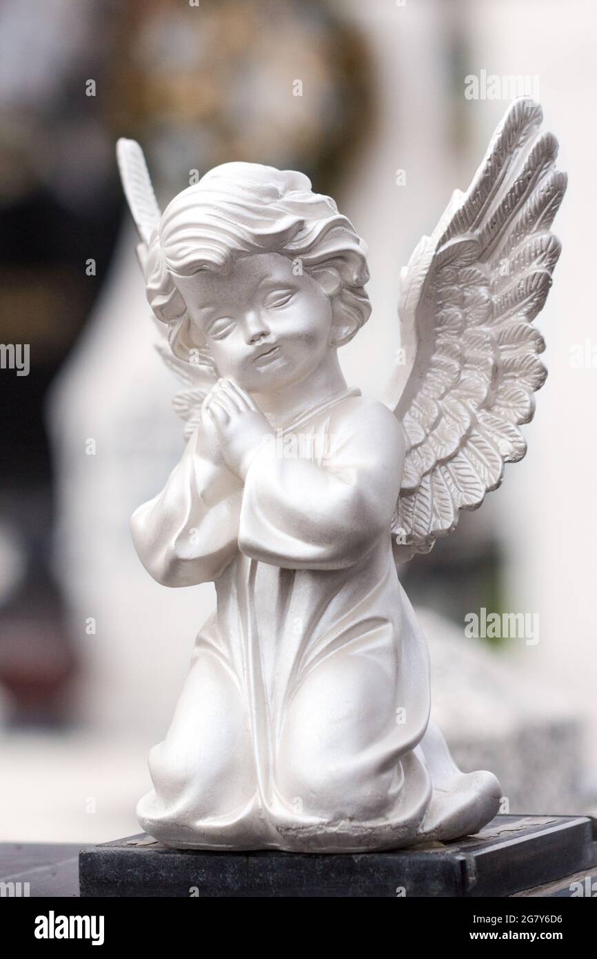 Vertical shot of a praying angel sculpture Stock Photo - Alamy