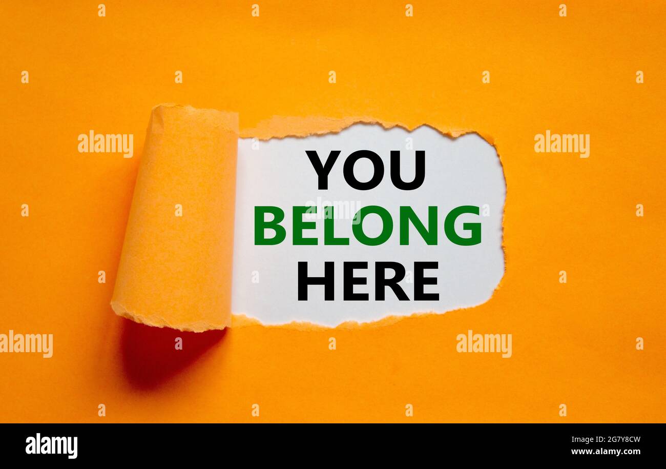 You belong here symbol. Words 'You belong here ' appearing behind torn ...