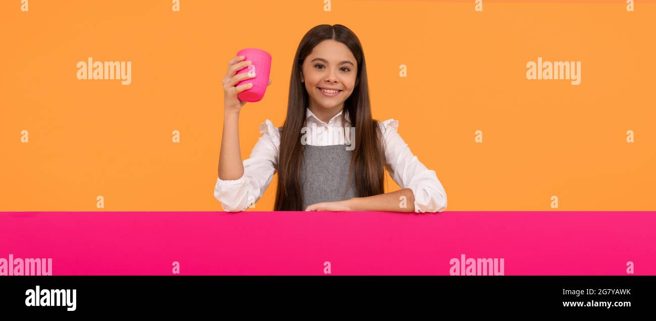 Happy kid hold plastic cup with drink and placard for copy space ...