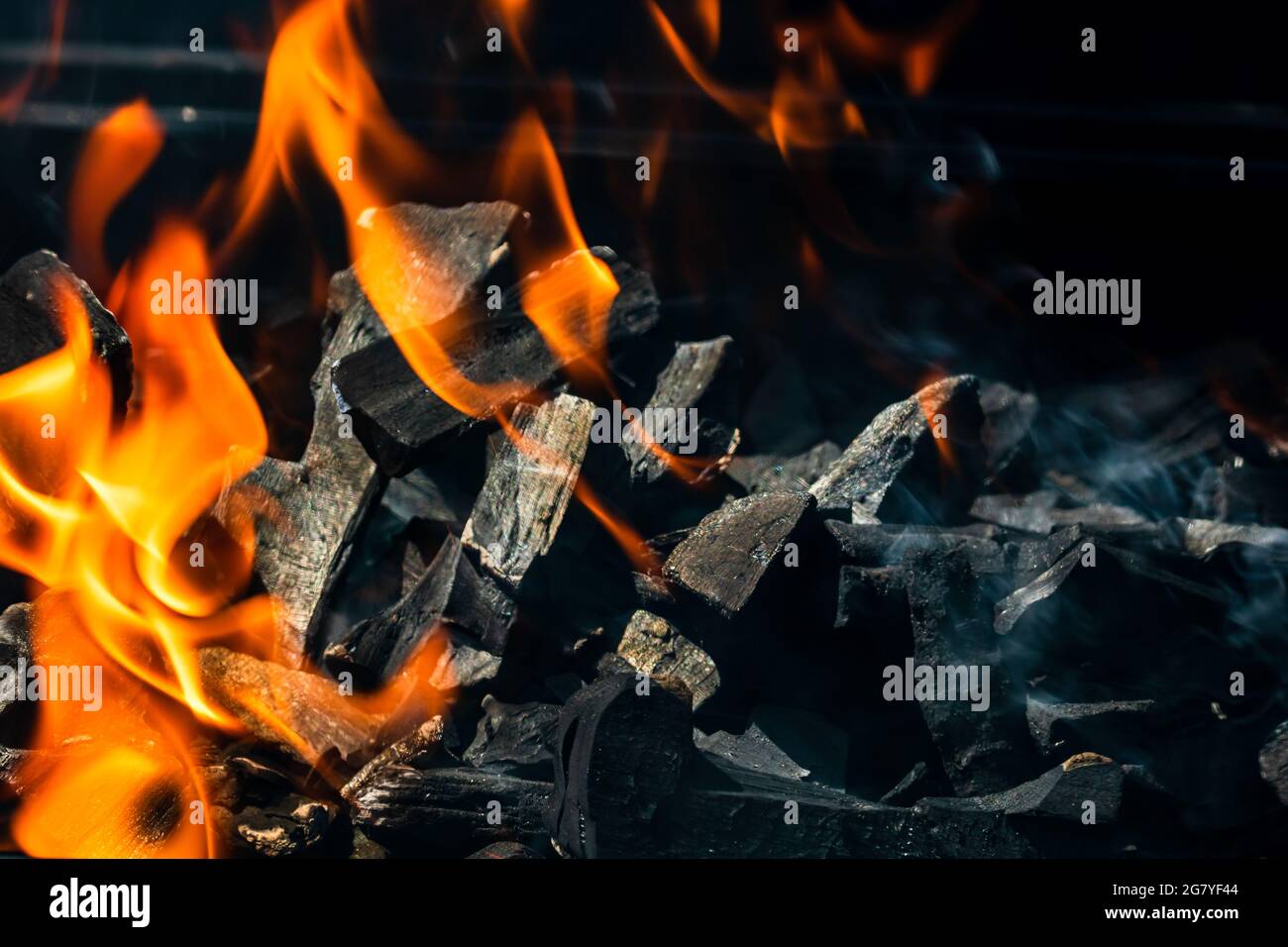 Barbecue grill pit with glowing and flaming hot open fire with red ...