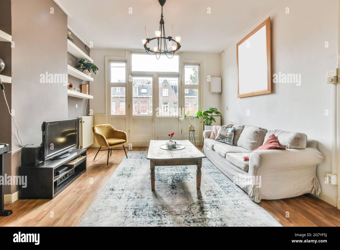 White guest room with sofa table and curtainless windows Stock Photo ...