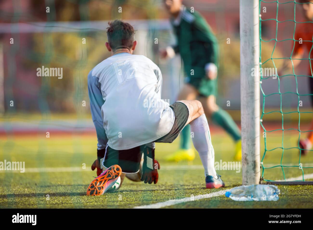 Adult Football Goalkeeper Player Catching Ball in a Goal. Soccer Player ...