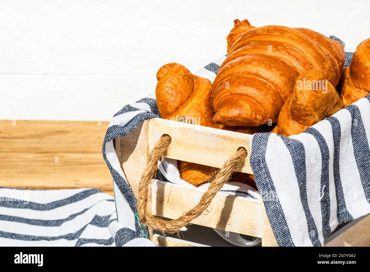 Fresh croissant, puff pastry and buttered french croissant on wooden ...