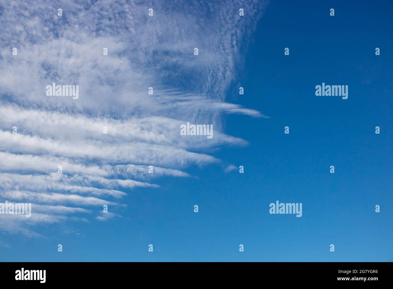 Blue, beautiful sky background. Oddly shaped clouds in a blue sky Stock Photo - Alamy
