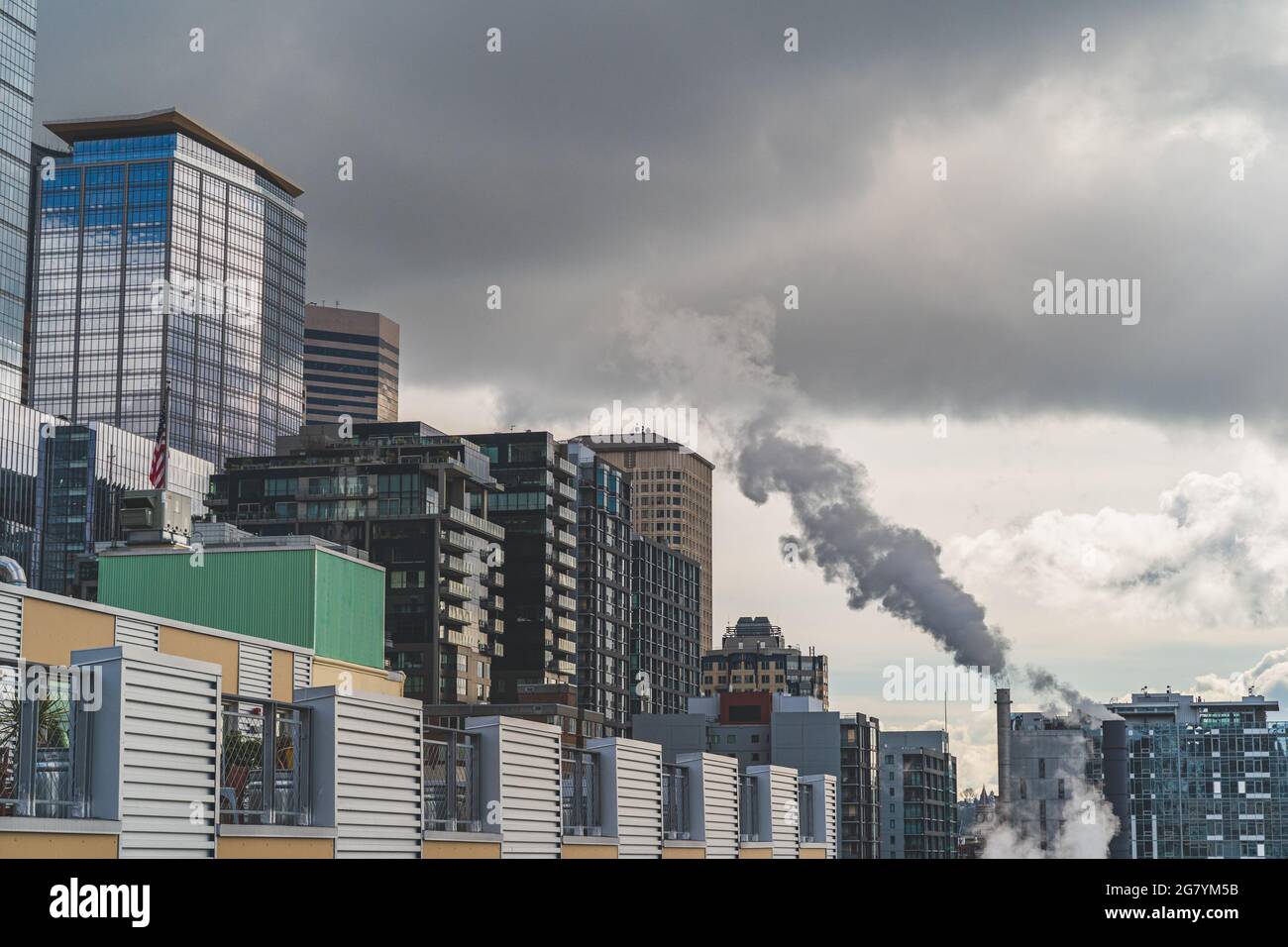 Cityscape of Seattle with dark clouds and dark vapor rising from smoke ...
