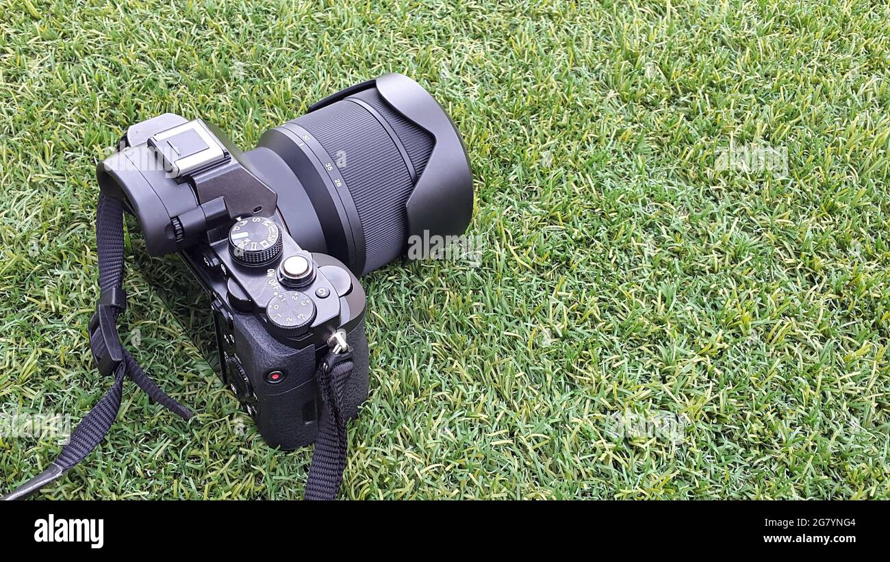 Digital photo camera on grass in summer Stock Photo - Alamy