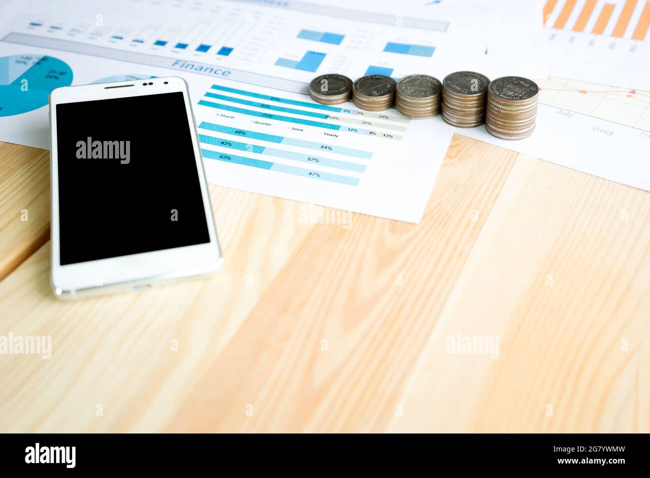 Stack coin and smartphone on table with statistic graph diagram Stock ...