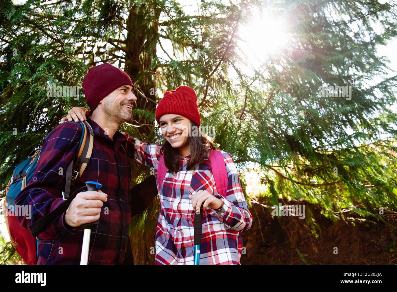 Happy father and teenage daughter having fun hiking in a sunny autumn ...