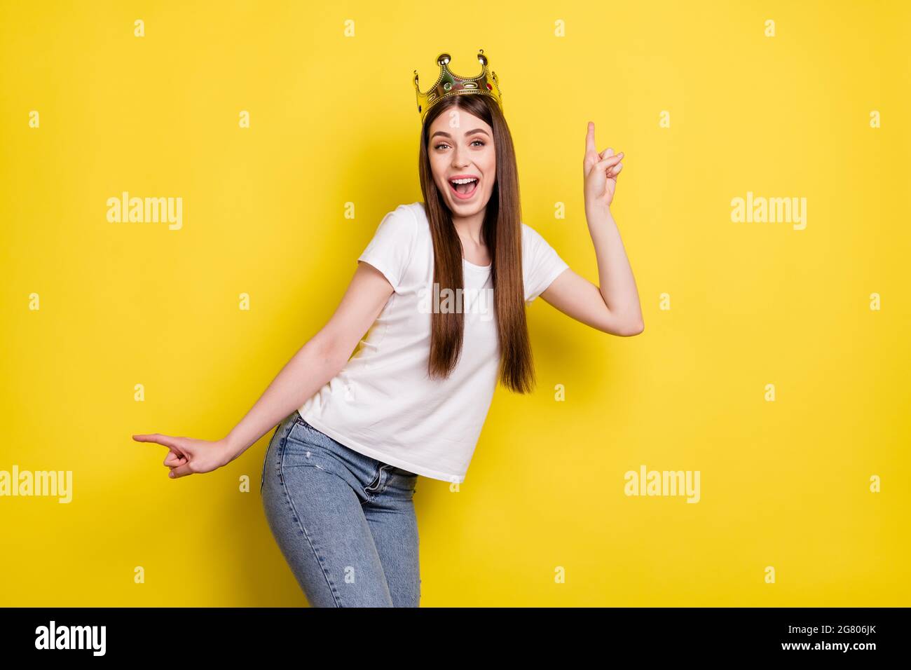 Portrait of attractive trendy cheerful girl wearing crown dancing ...