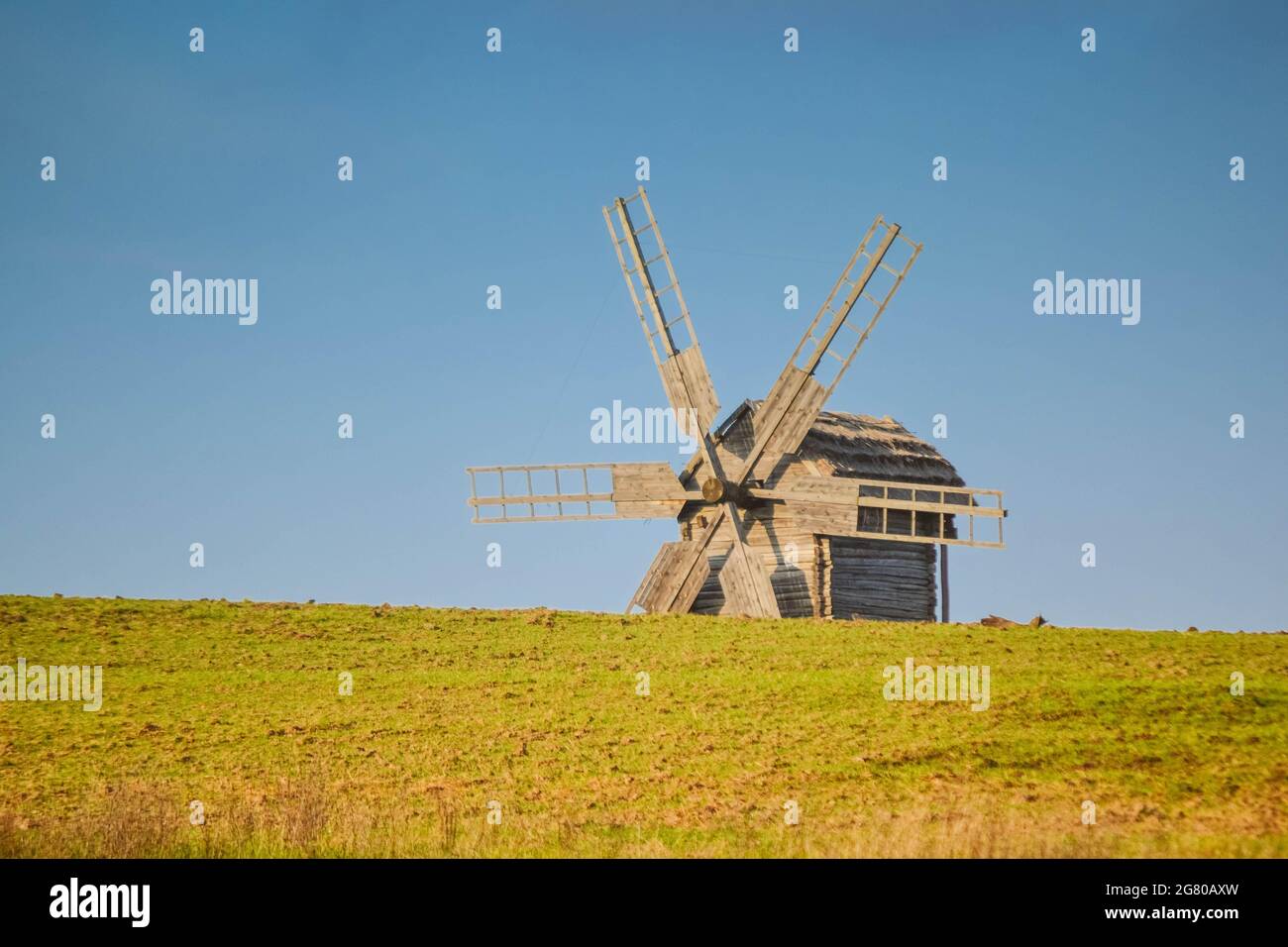 old windmill on the field Stock Photo - Alamy