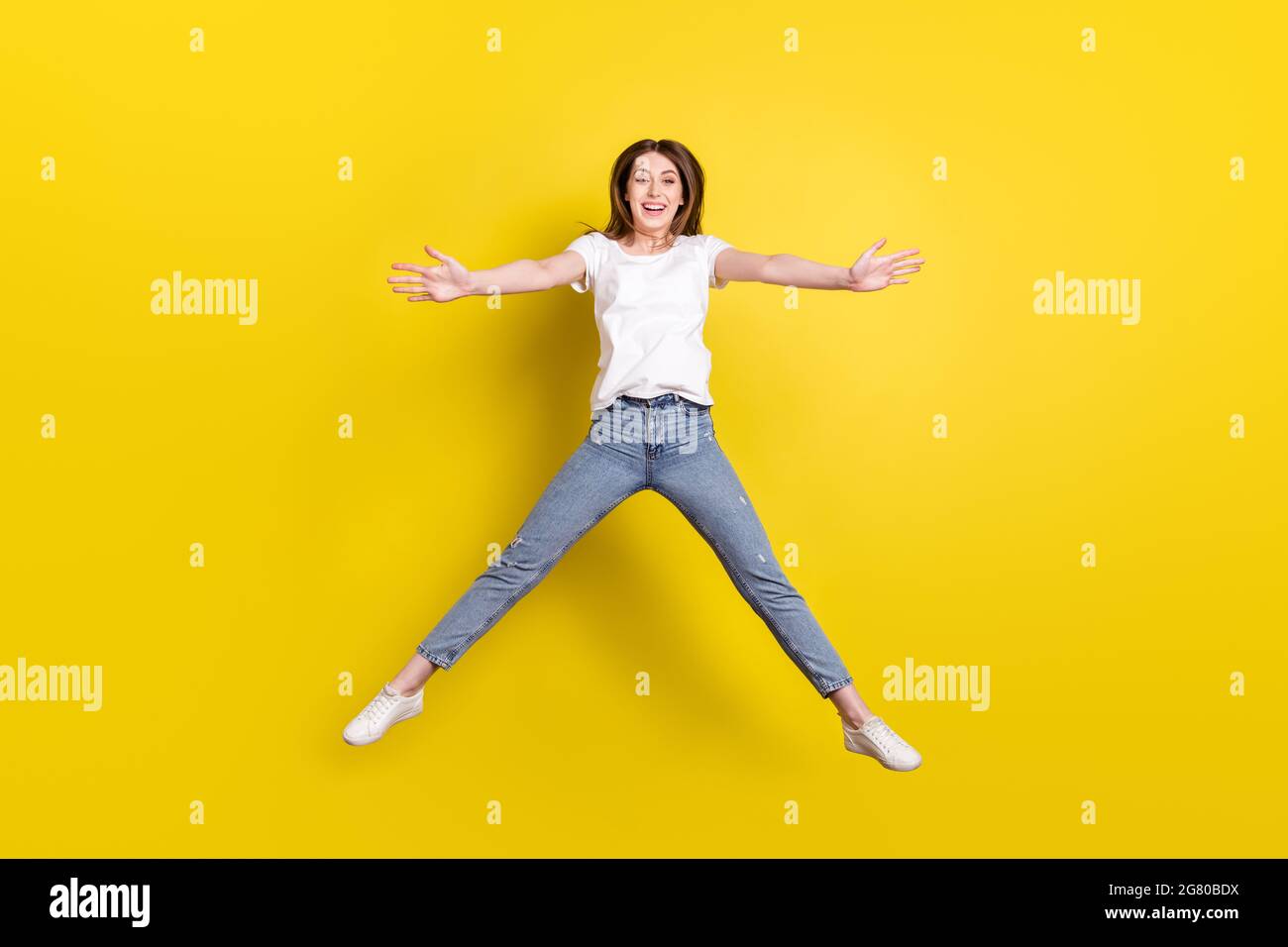Full length photo of young girl happy positive smile jump up open arms ...