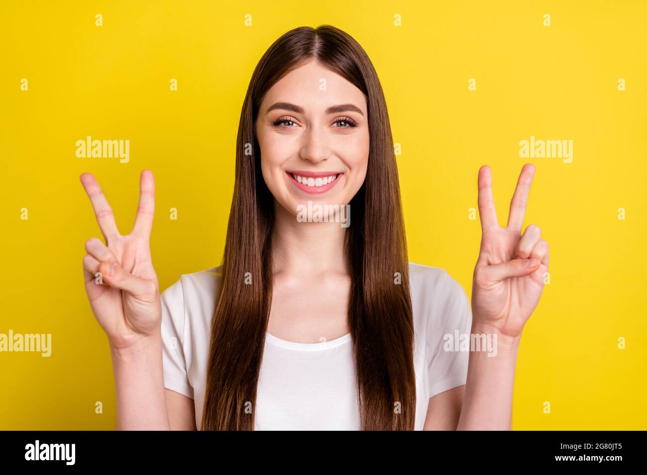 Portrait of attractive cheerful girl showing double v-sign good mood ...