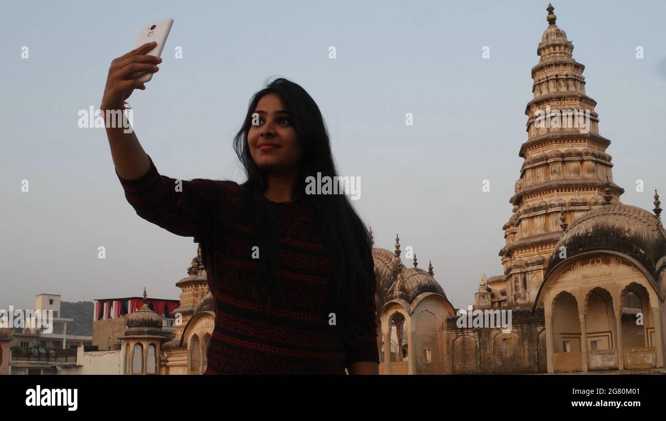Indian Female Taking Selfie With Mobile On The Background Of An Ancient