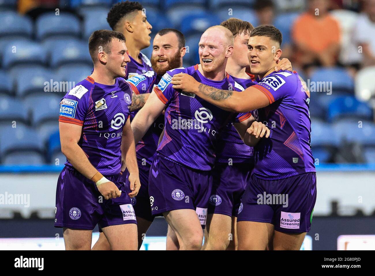 Liam Farrell (12) of Wigan Warriors celebrates his try with team mates ...