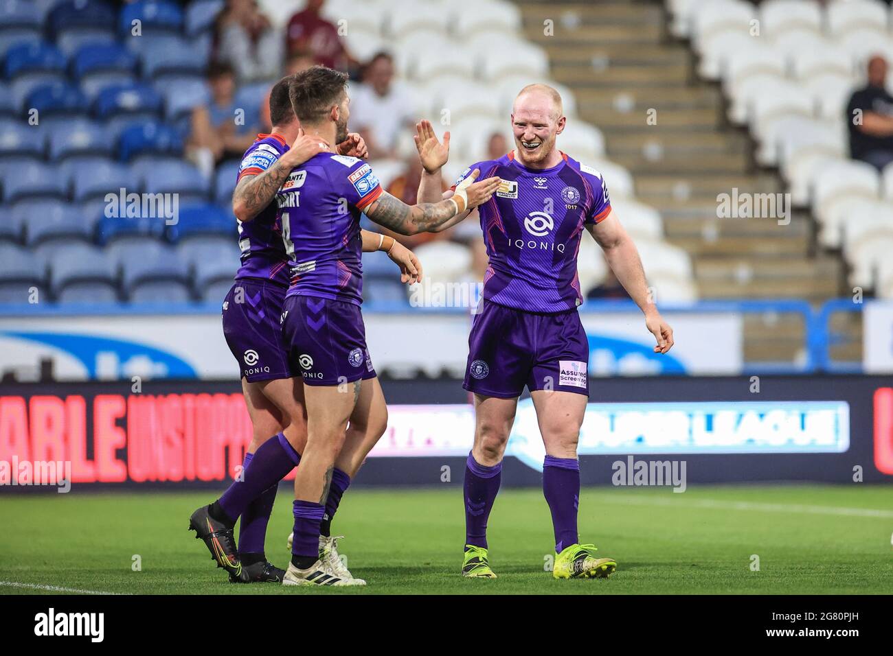 Liam Farrell (12) of Wigan Warriors celebrates his try with team mates ...