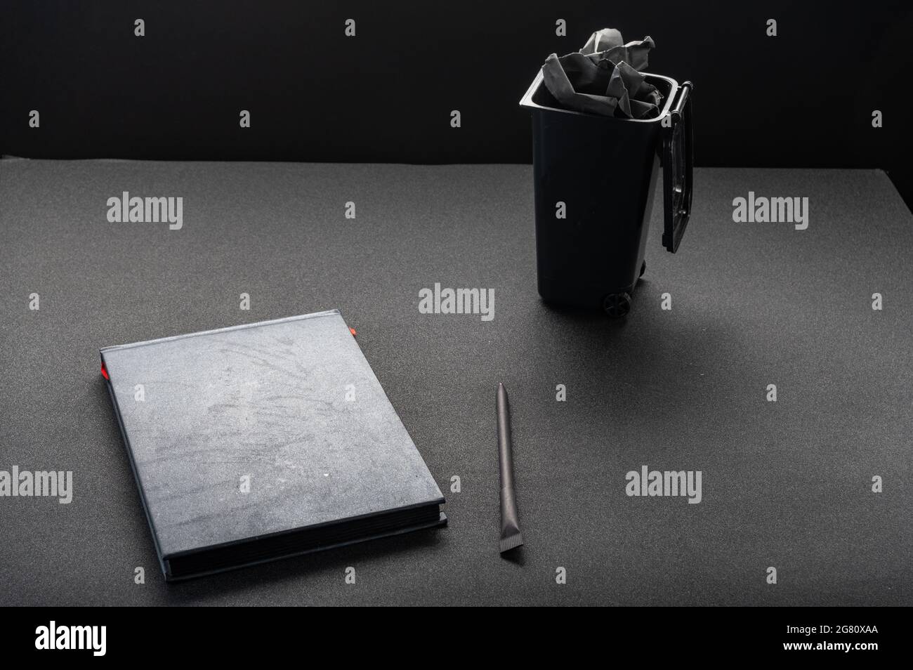 Notebook and trash can. Crumpled paper in the trash bin. Search for an ...